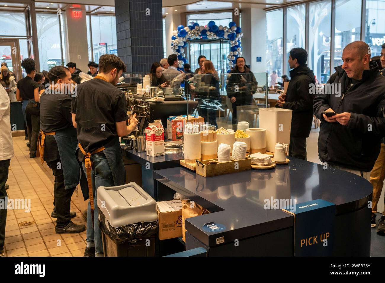 Customers and potential customers celebrate the grand opening of a ...