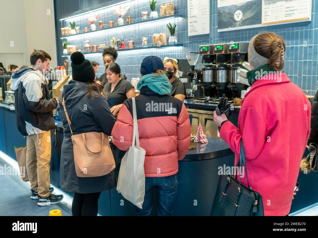 Customers and potential customers celebrate the grand opening of a ...