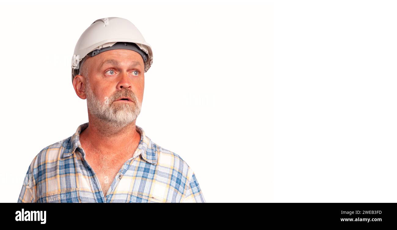 Surprased Surveyor builder site engineer in white hard hat in shock and ...