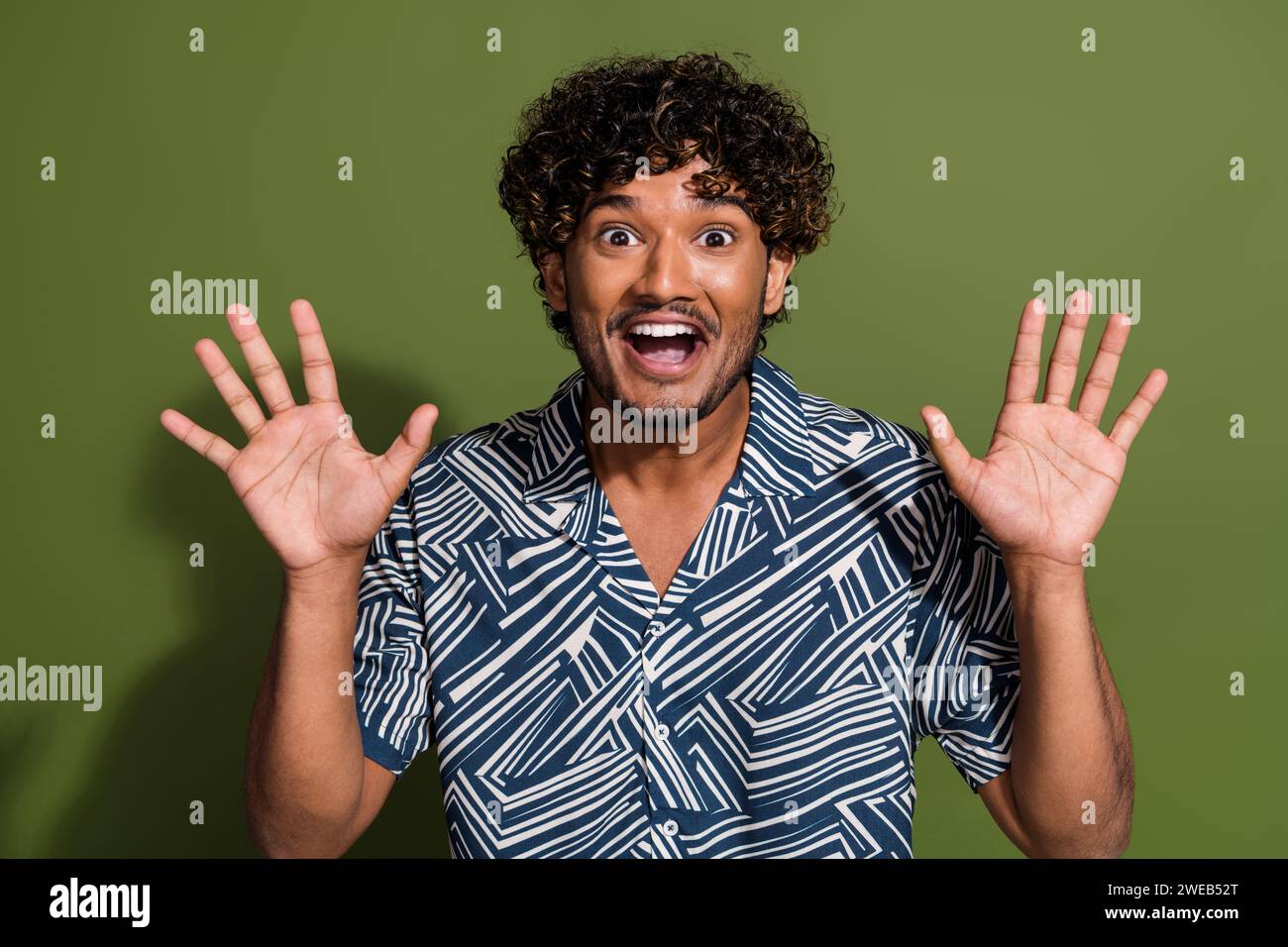 Portrait of young funny mexican man raised two arms count number ten ...