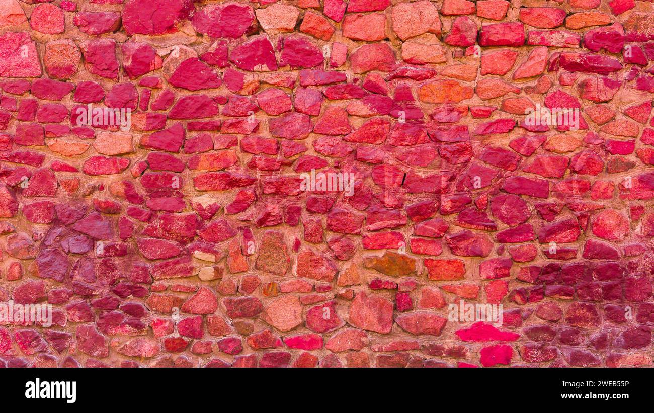 Close-up of the texture of a dark red stone wall Stock Photo - Alamy