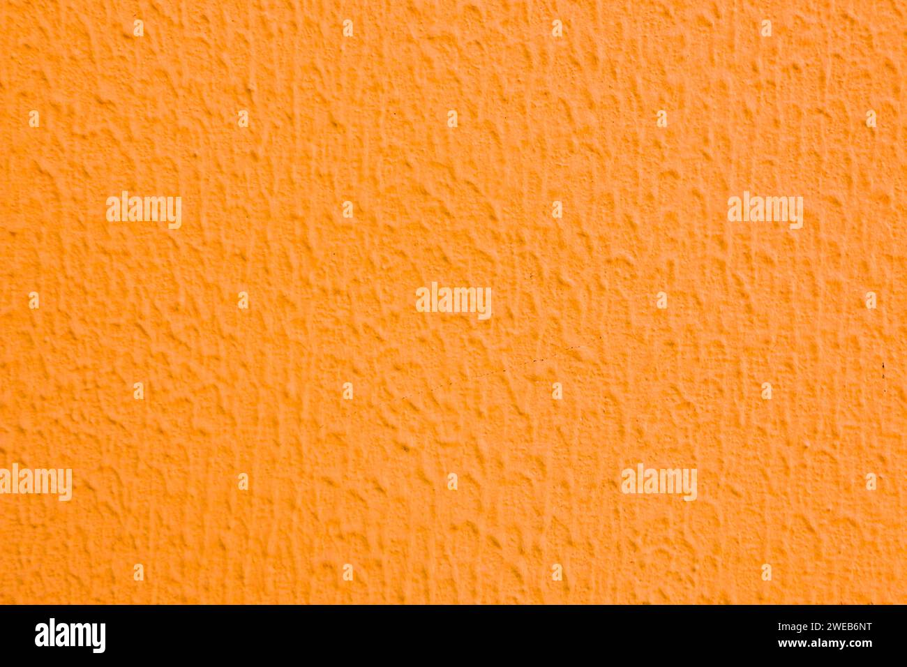 A wall with worn orange plaster Stock Photo - Alamy