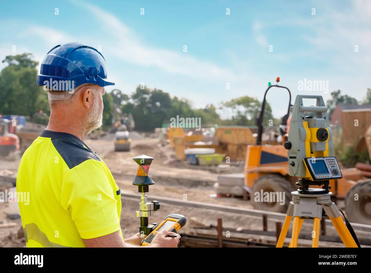 A man site engineer surveyor working with theodolite total station EDM ...