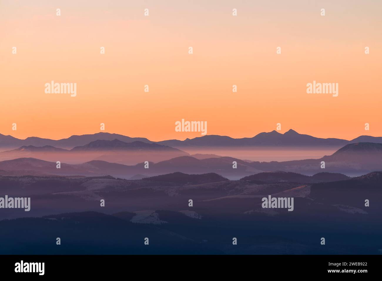 High mountain ranges in dense fog. Layers of mountains in the haze ...