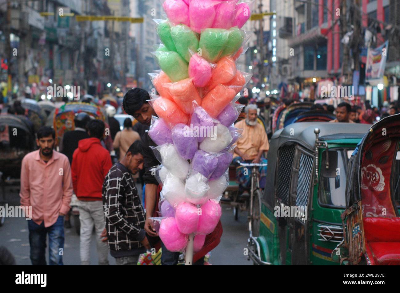 Dhaka, Bangladesh. 25th Jan, 2024. A candy seller waits for customers at the New Market in Dhaka ...