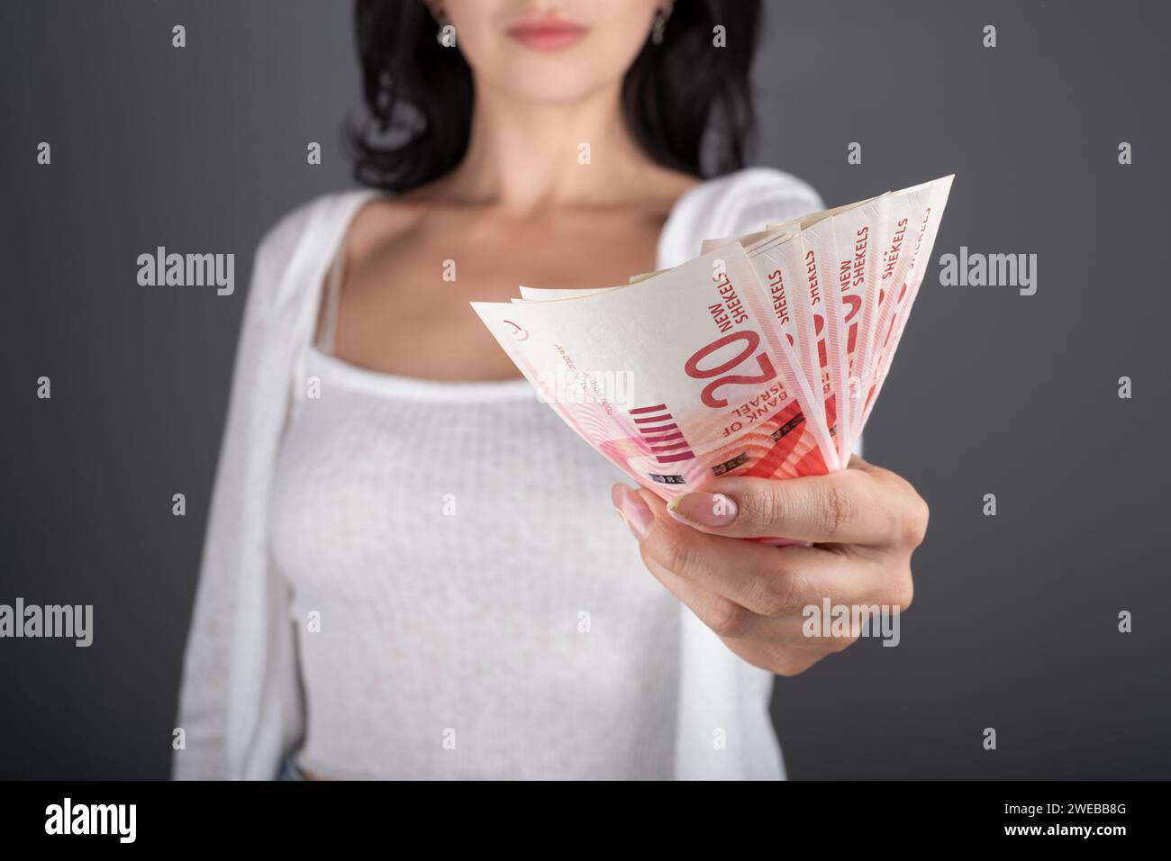 New Israeli shekels banknotes in nominal 20 nis. Women give shekels on ...