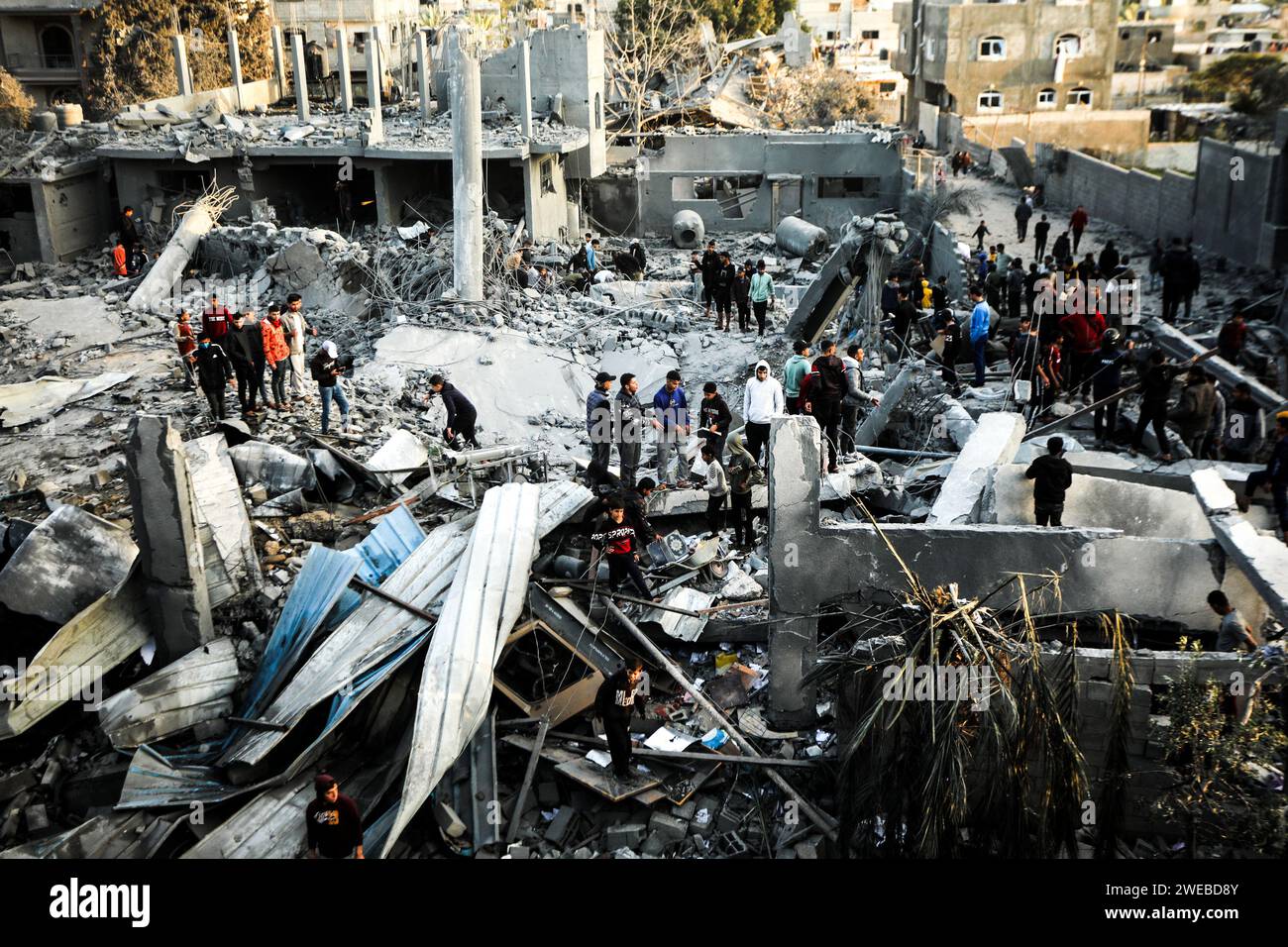 Rafah, Gaza. 24th Jan, 2024. Palestinians search for victims after an ...