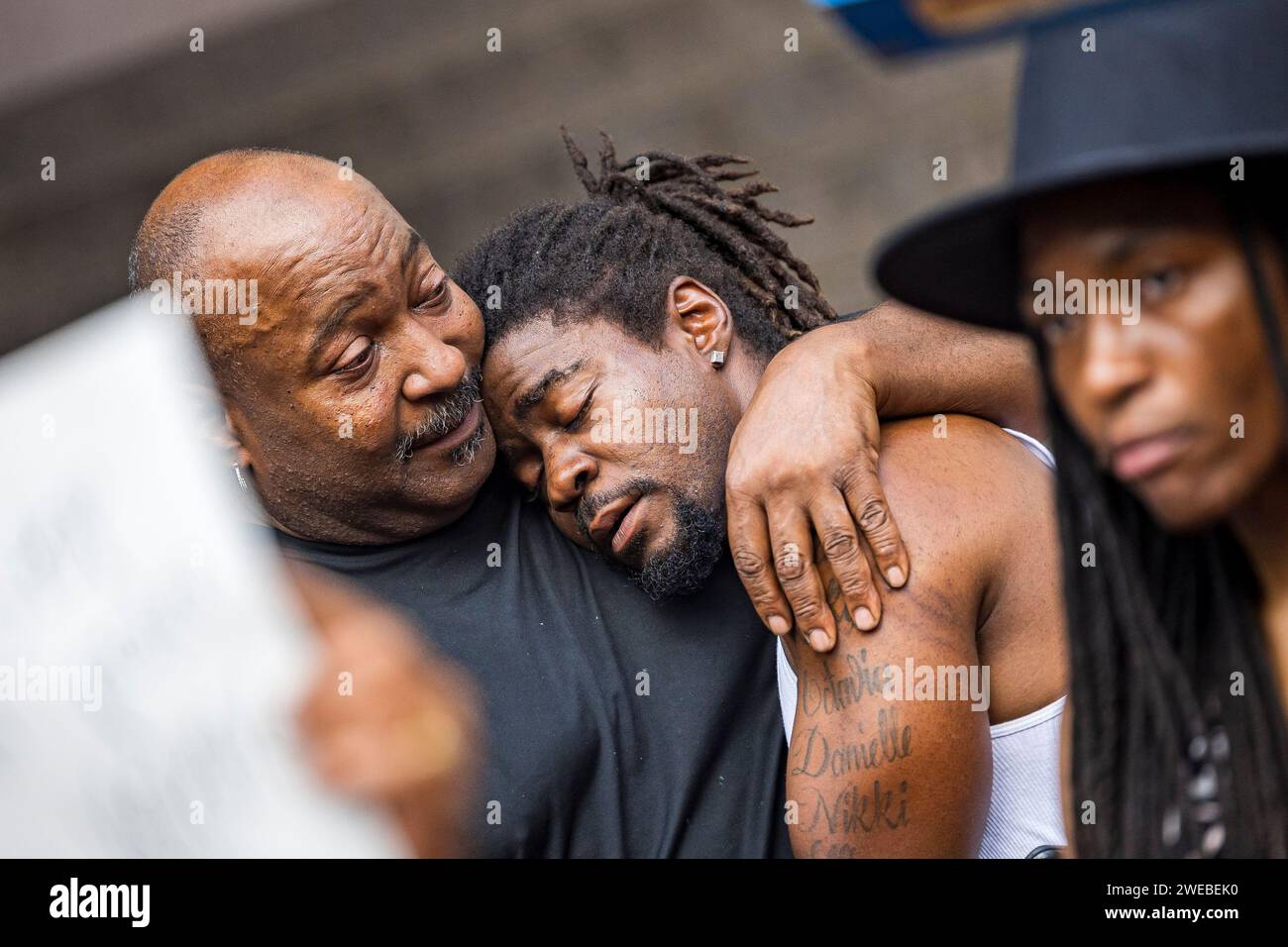 Rashad Cobb, Ricky Cobb II's twin brother, leans on the shoulders of ...