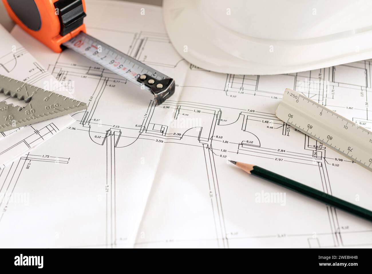 Architecture plans and contractor supplies on desk Close up. Copy space ...