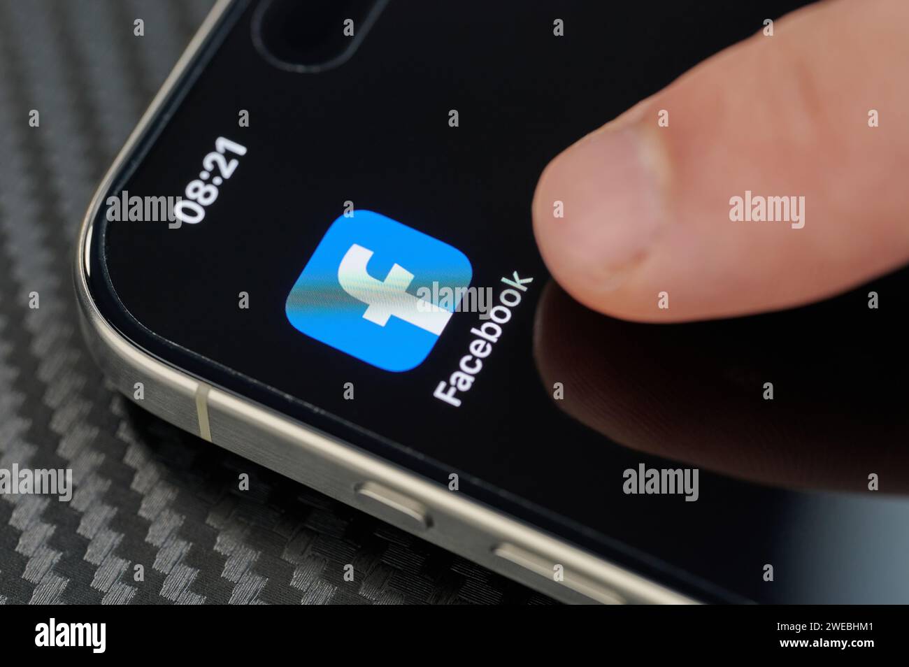 New York, USA - January 24, 2024: Touching top open Facebook app icon ...