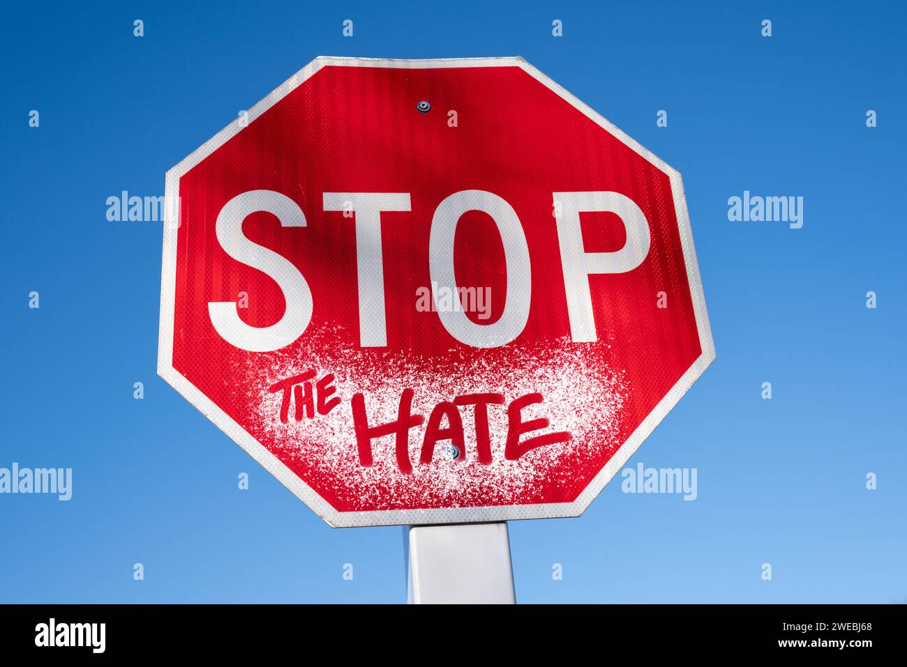 Photo of a traffic stop sign with the saying stop the hate in spray ...