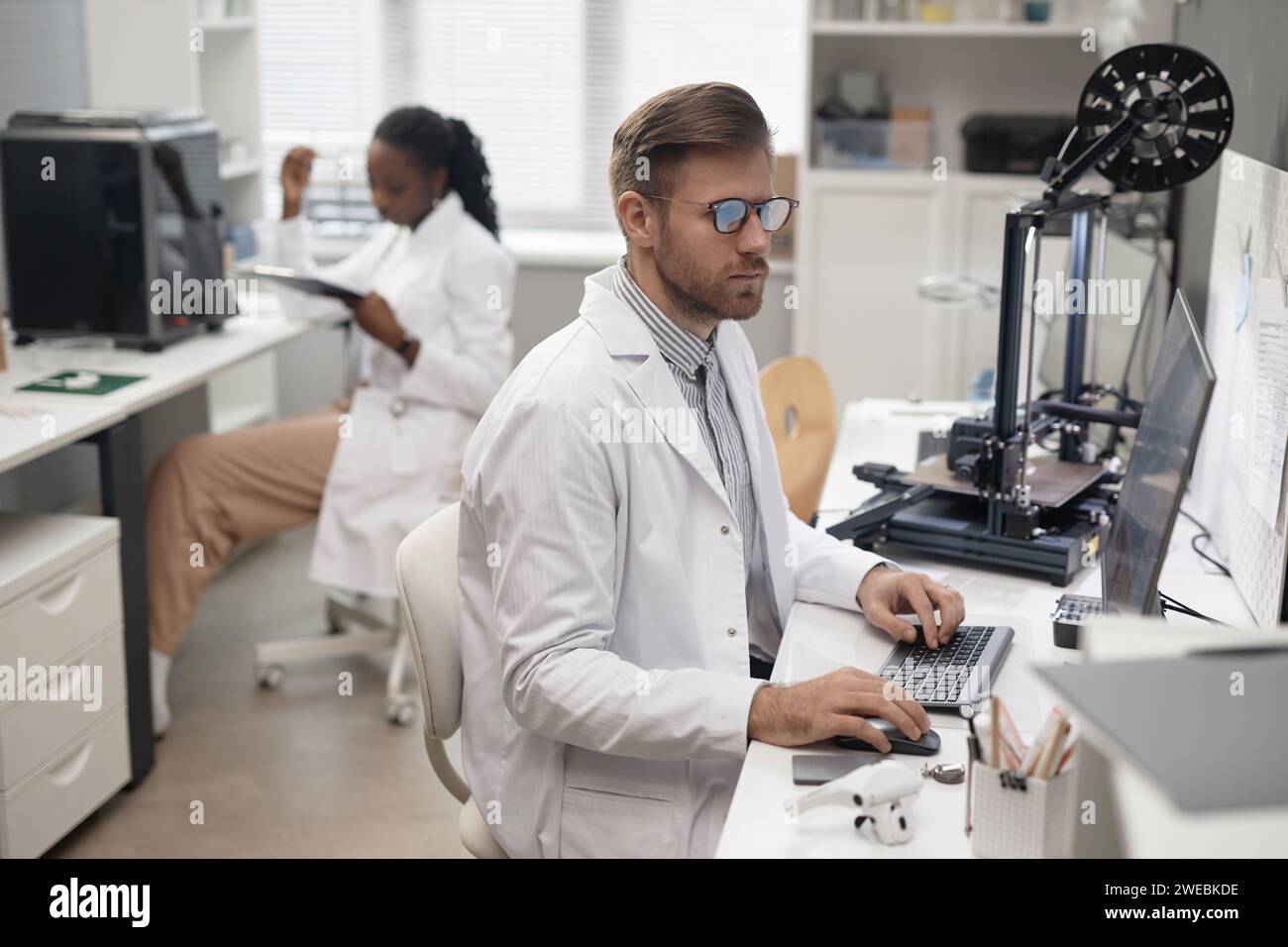 Male Technician Using Computer in 3D Printing Lab Stock Photo - Alamy