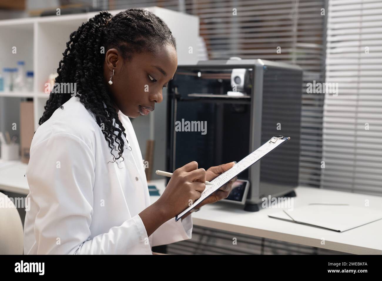 Female 3D Printer Engineer Writing on Clipboard Stock Photo - Alamy