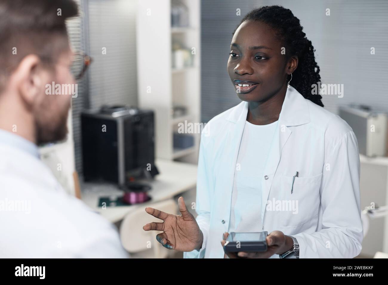 People talking by printer hi-res stock photography and images - Alamy