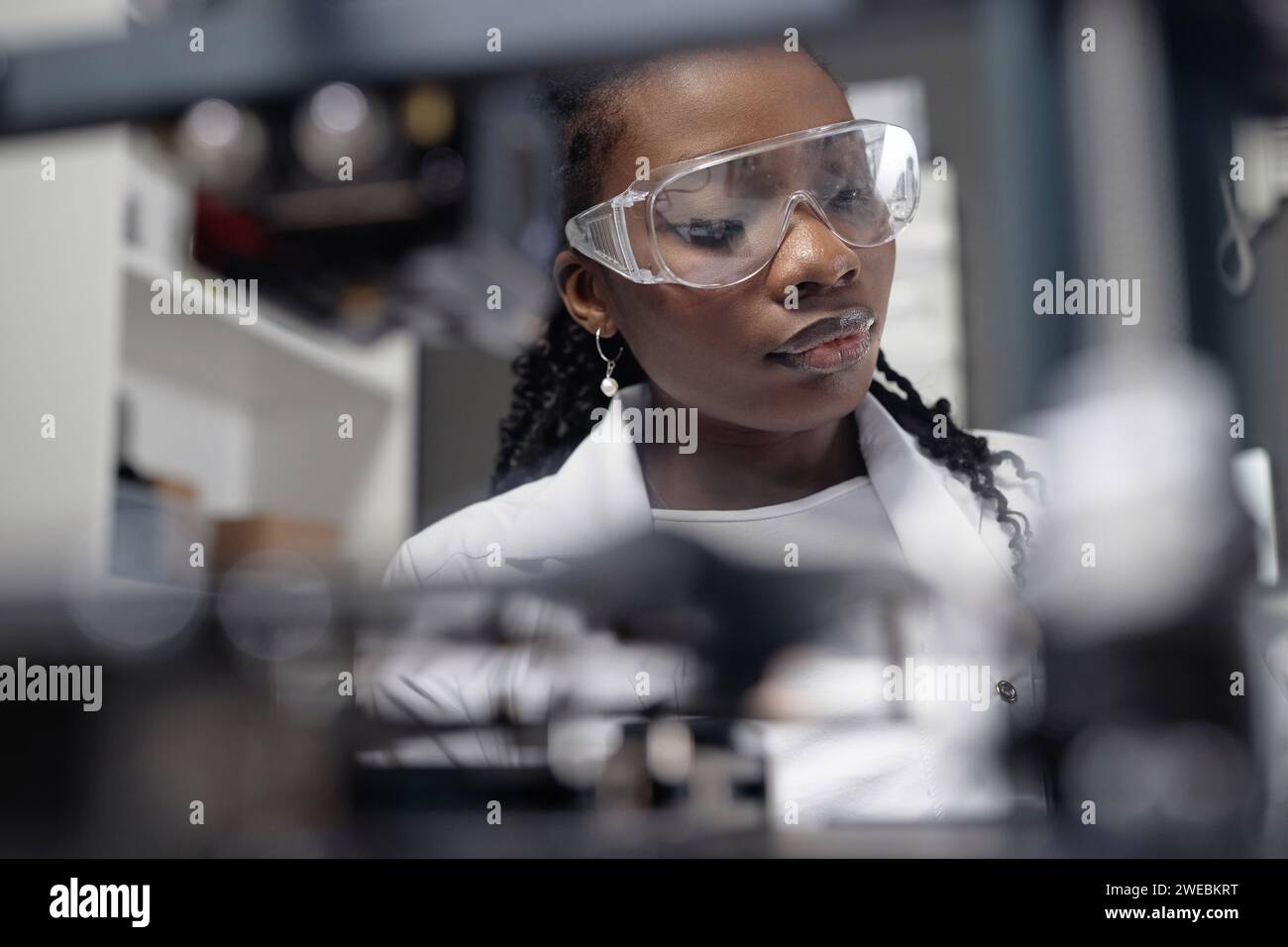 Female Technician Wearing Safety Glasses in Laboratory Stock Photo - Alamy