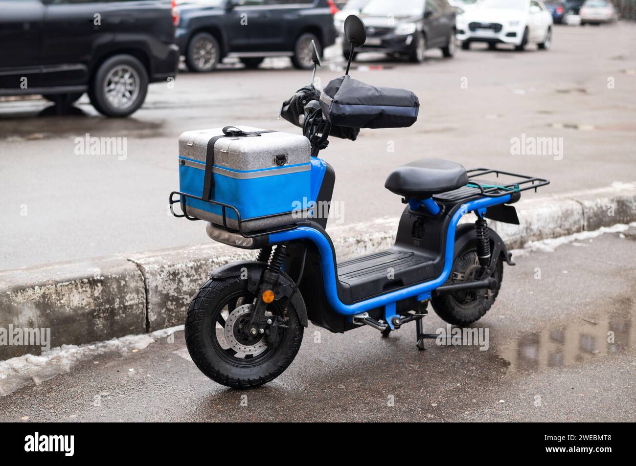 An electric scooter for cargo transportation with a front and rear ...
