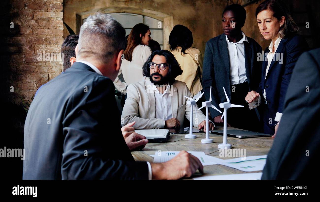 Renewable energy. Business people meeting working on environment and ...