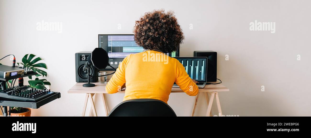 African host woman recording podcast using microphone at home studio ...