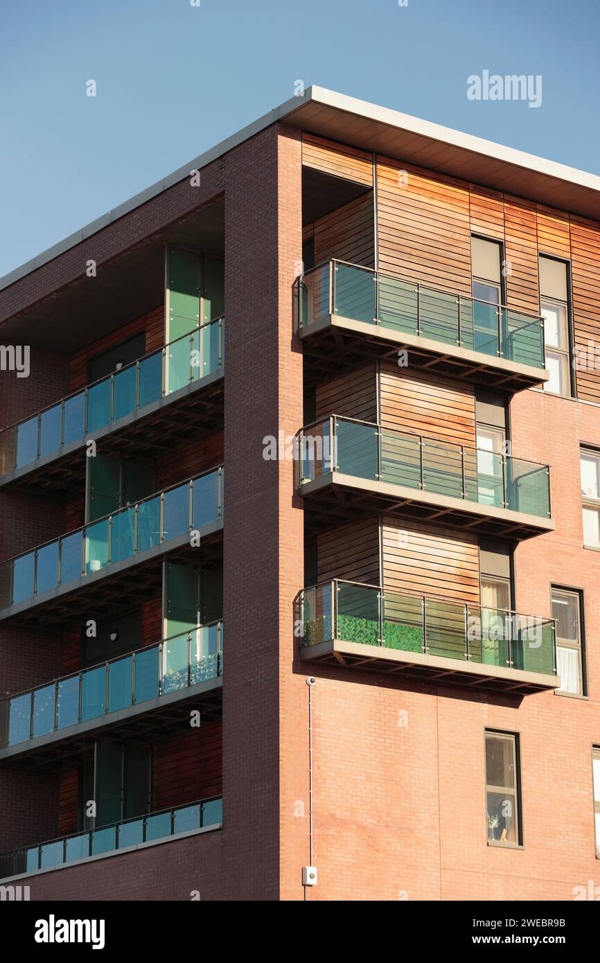 Multi storey residential building, red brick, timber cladding and glass ...