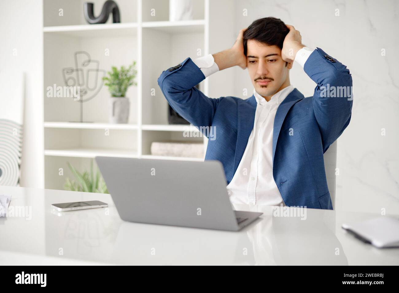 Concerned businessman in suit holds hi-res stock photography and images ...