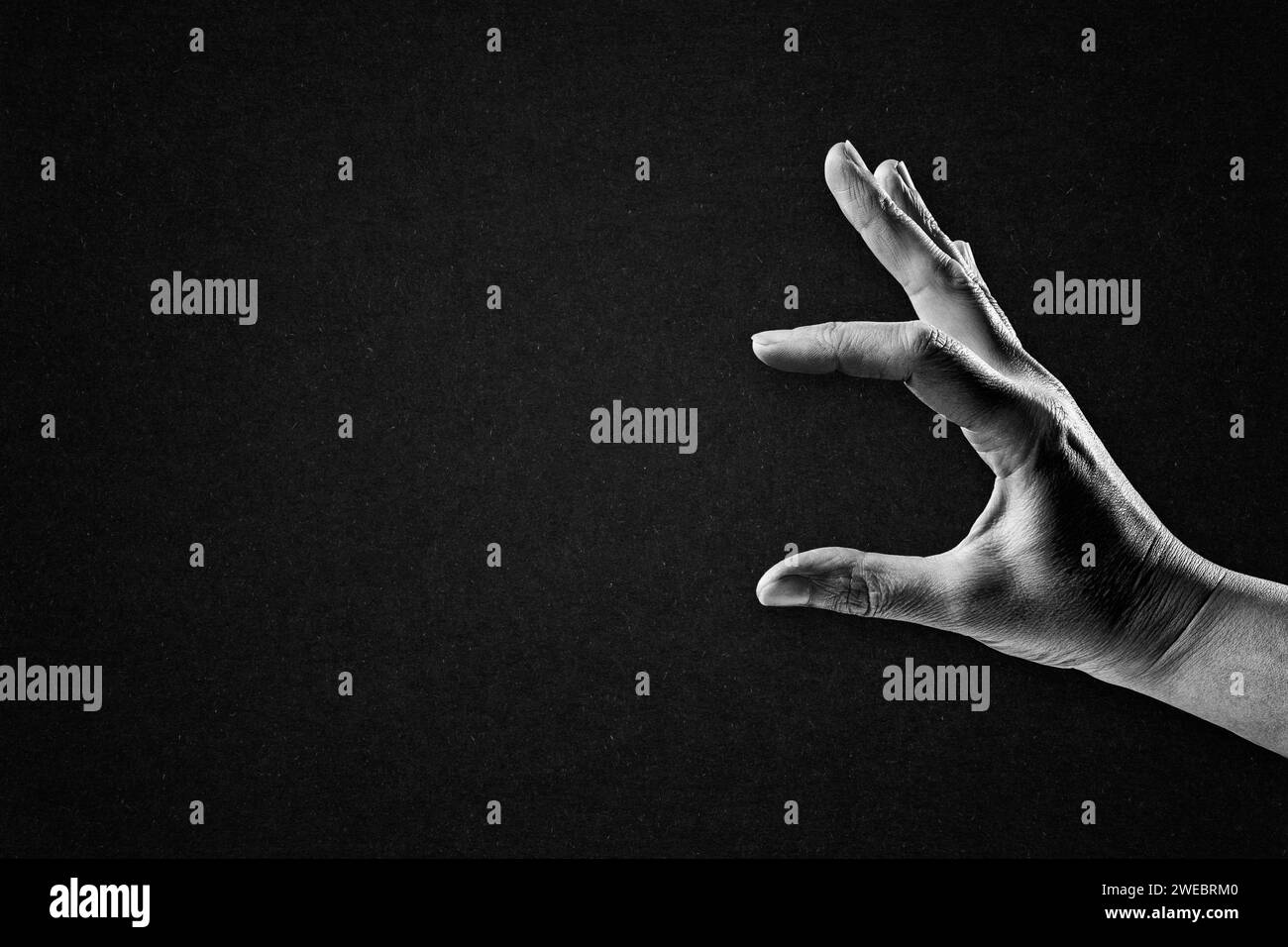 Hand Holding Something Sign in Black and White on Textured Paper ...