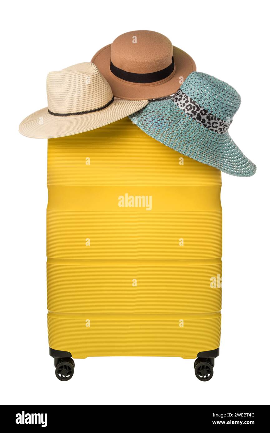 Travel yellow suitcase with hats hanging on top isolated on white ...