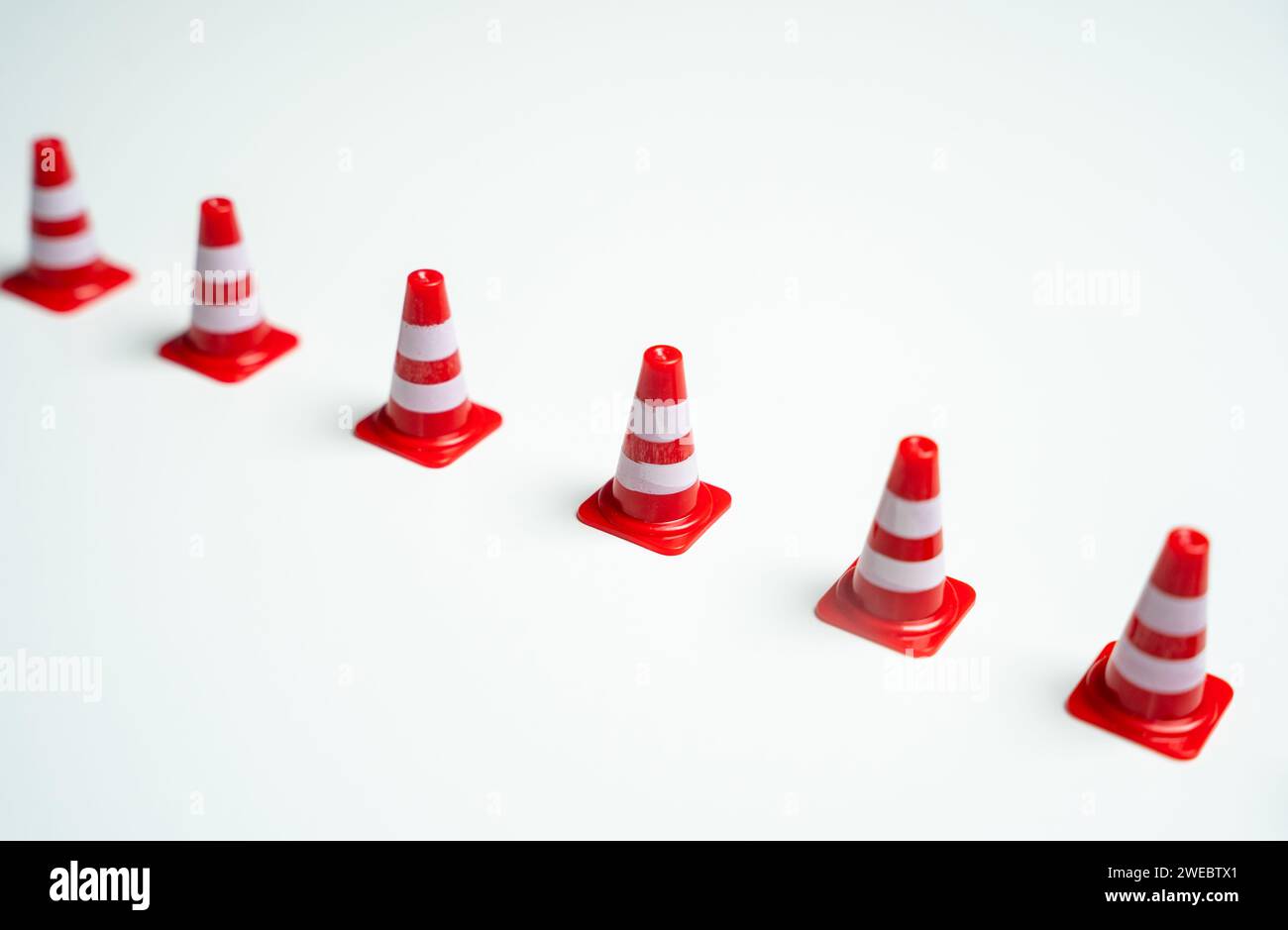 Road cones in a row. Barrier, fencing. Safety and red lines, red flags ...