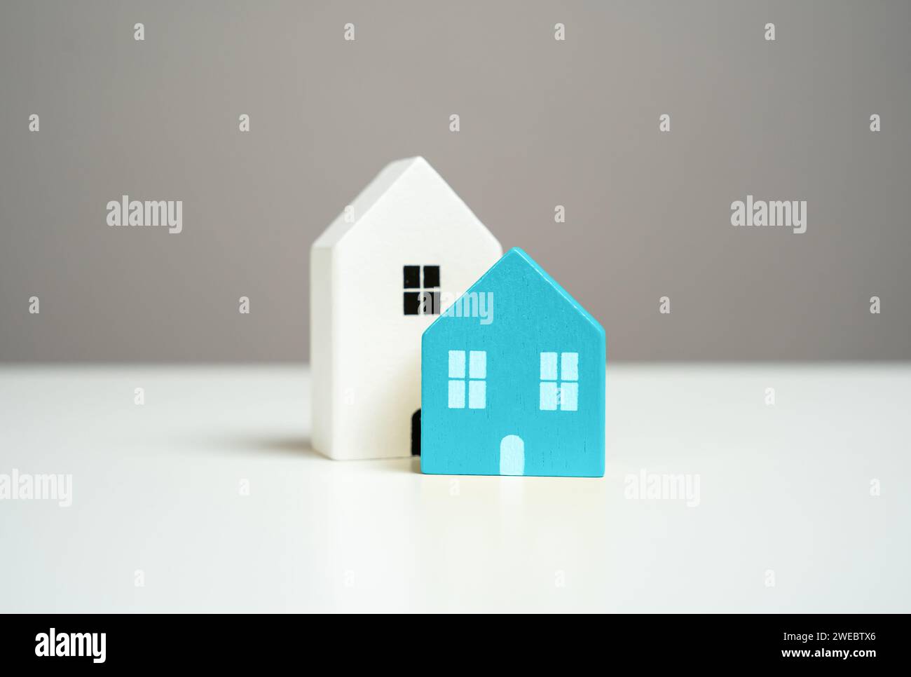 Wooden figures of houses, minimalism. Realtor services. Buying and ...