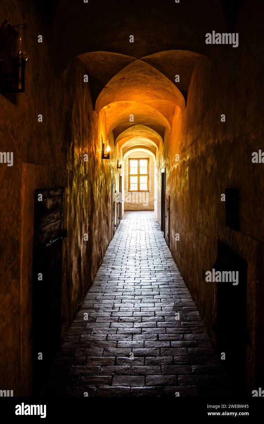 Dark and empty corridor of medieval castle Stock Photo - Alamy