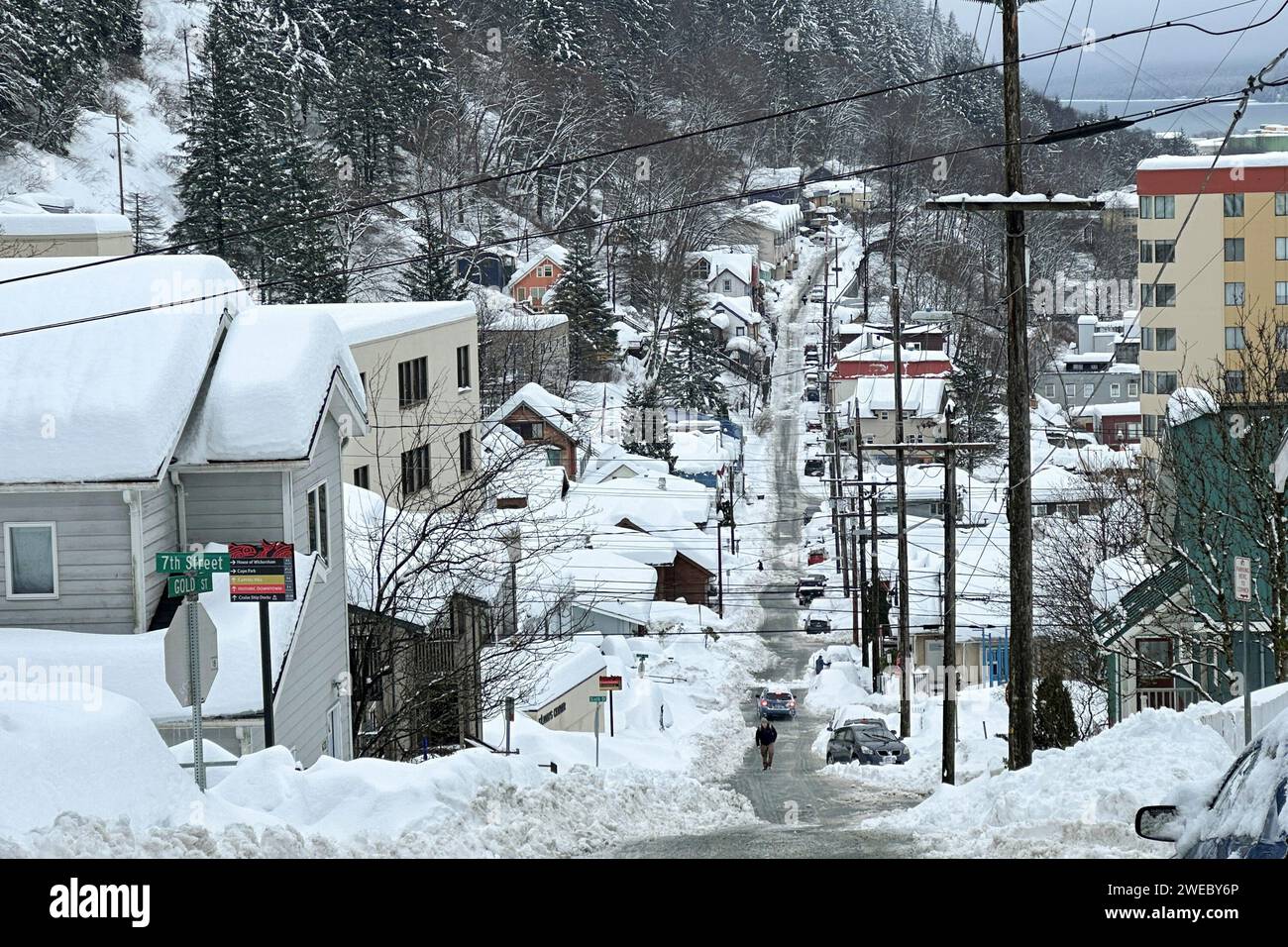 A pedestrian walks up a steep downtown street in Juneau, Alaska, on ...