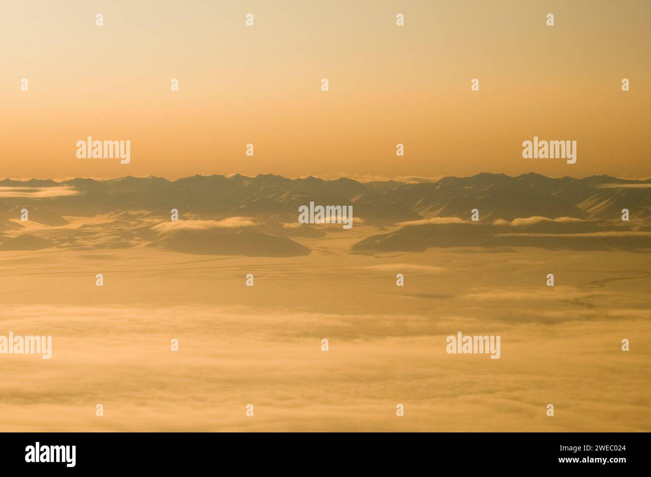 Aerial view of the frozen snow covered Brooks Range on the way to the ...