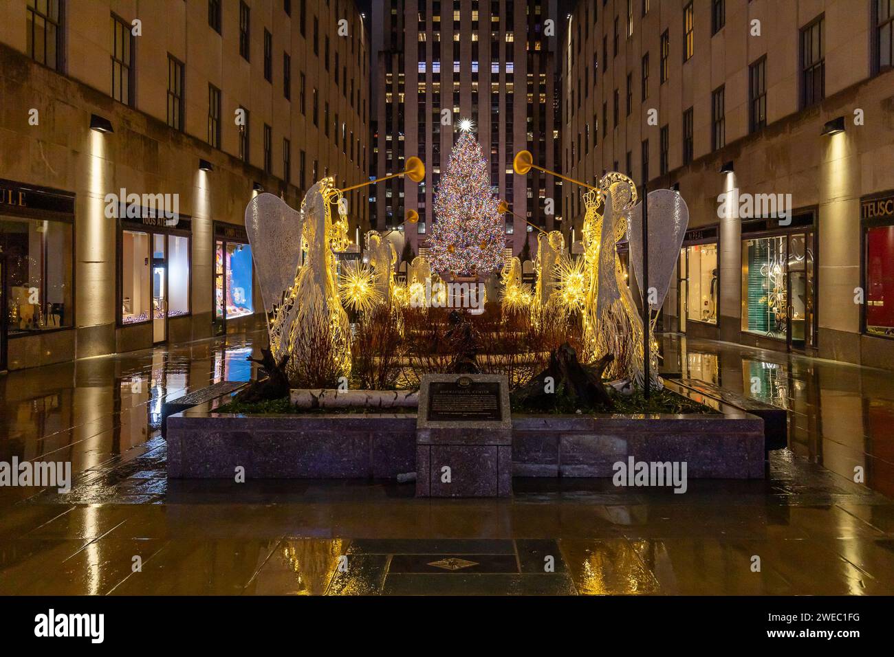 Rockefeller Center during Christmas time with the tree lit up and ...