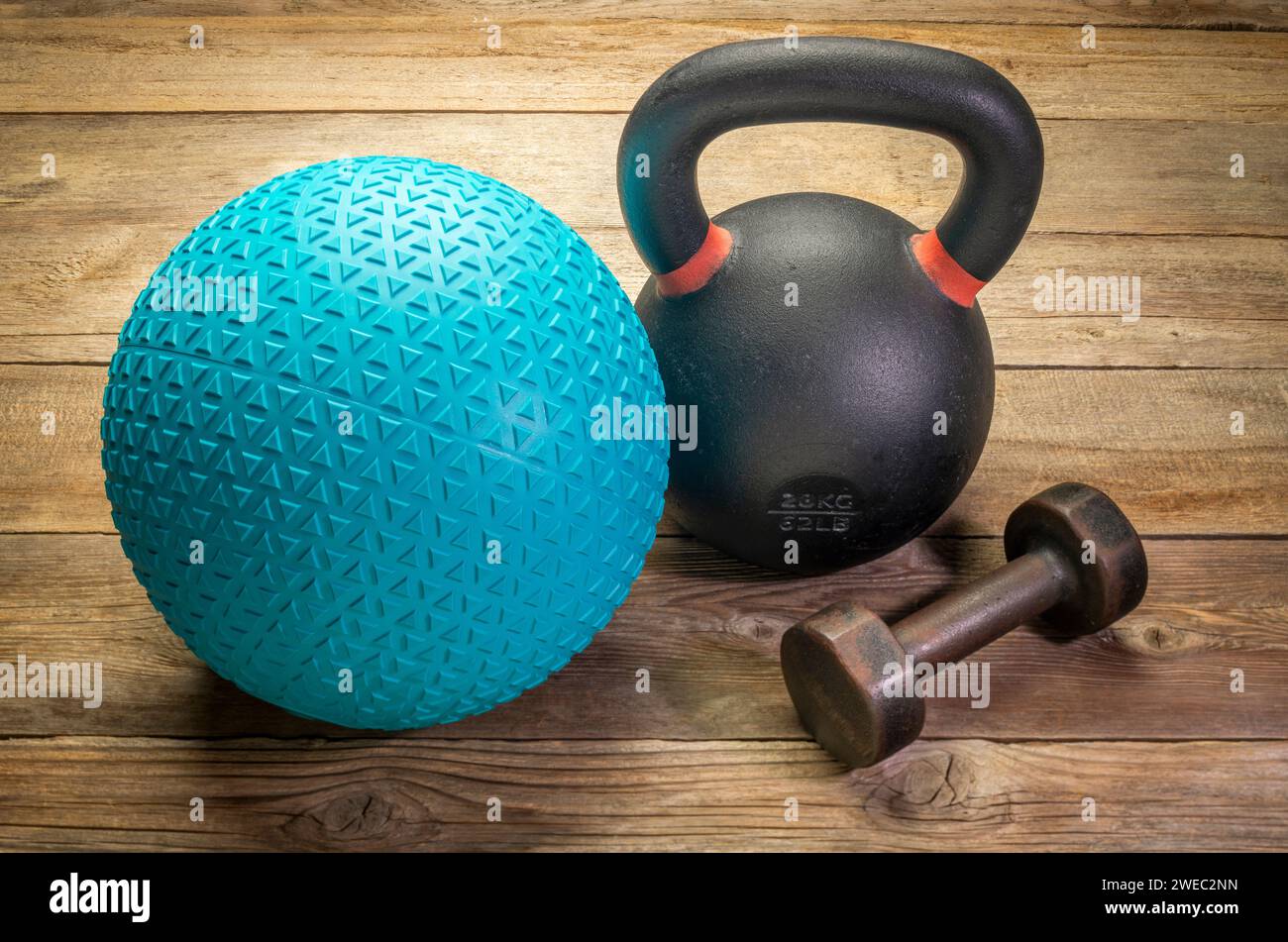 heavy rubber slam ball filled with sand, iron kettlebell and a small ...