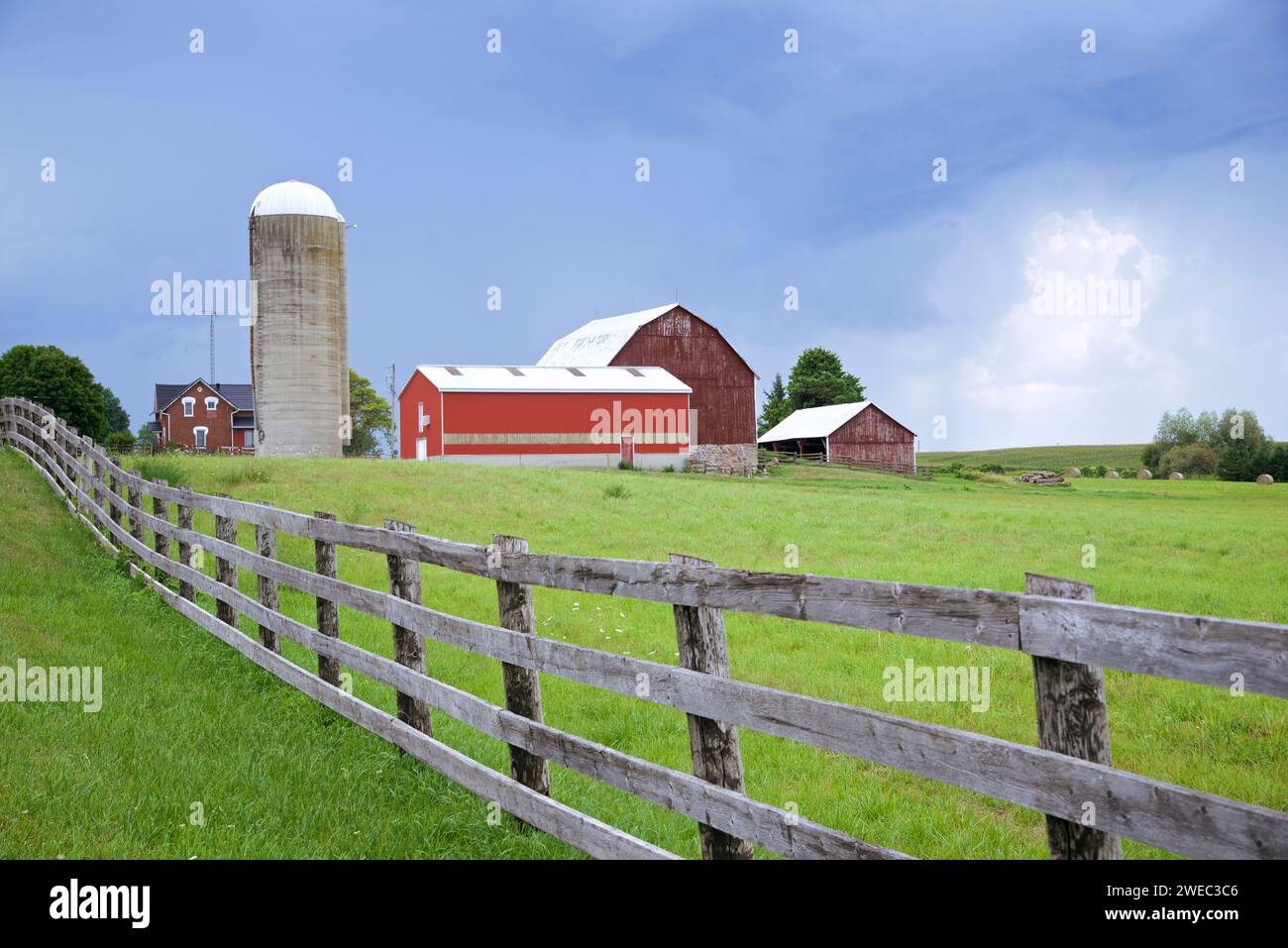 Agriculture landscape with red barn and silo with fence Stock Photo - Alamy