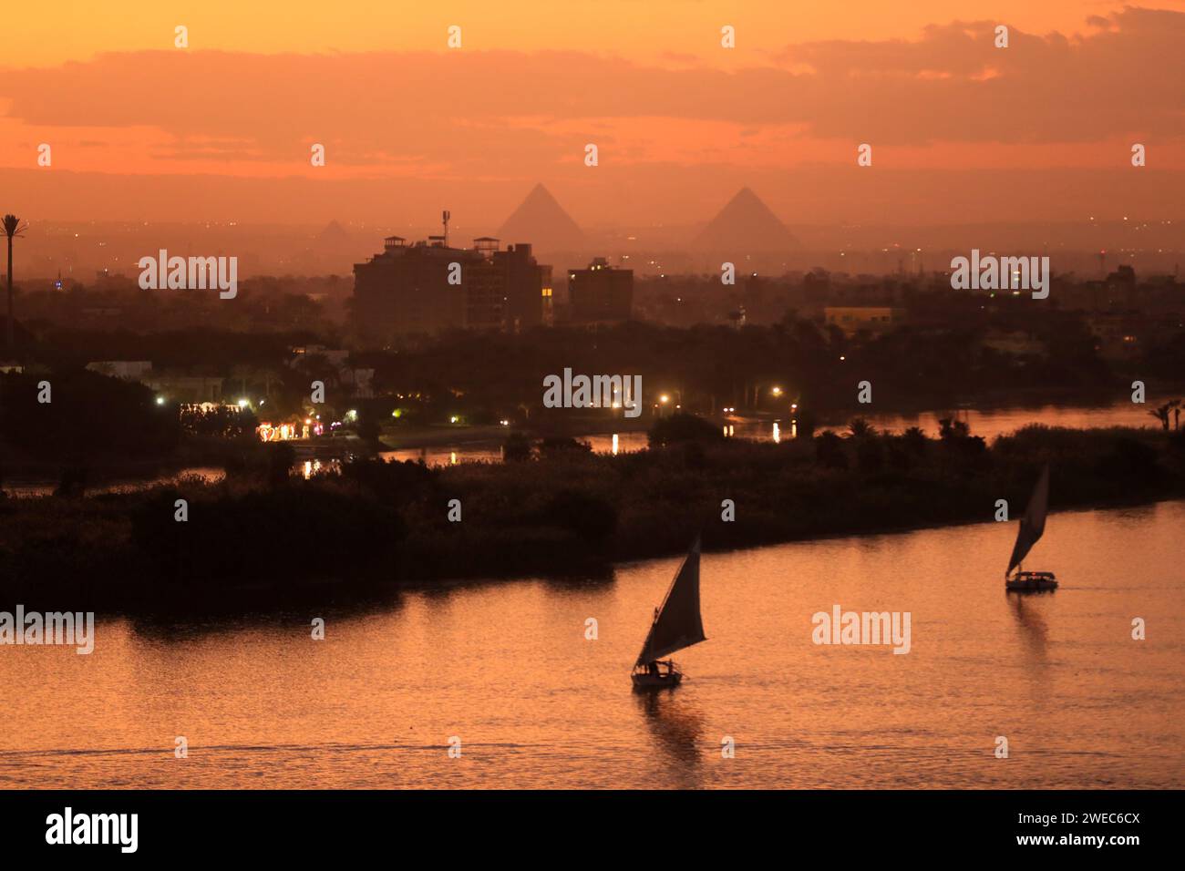 Cairo, Egypt. 24th Jan, 2024. Boats sail on the Nile River with Giza ...