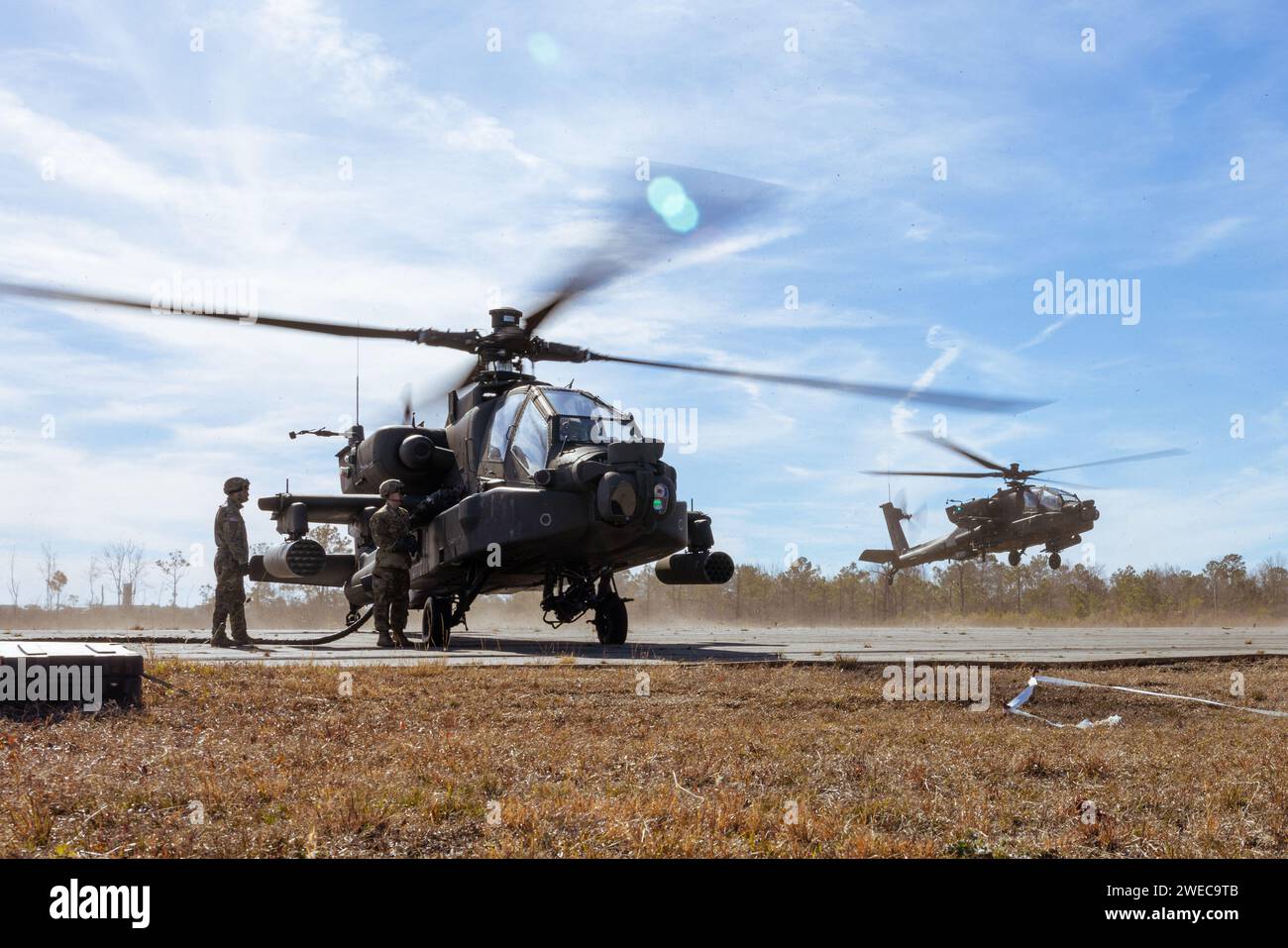 U.S. Army Soldiers refuel an AH-64E Apache during a forward arming and ...