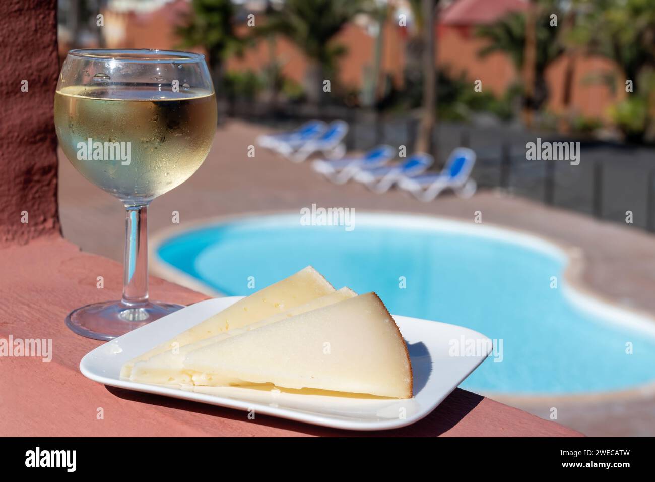 Spanish hard manchego, cow, sheep and goat cheese, glass of cold white ...