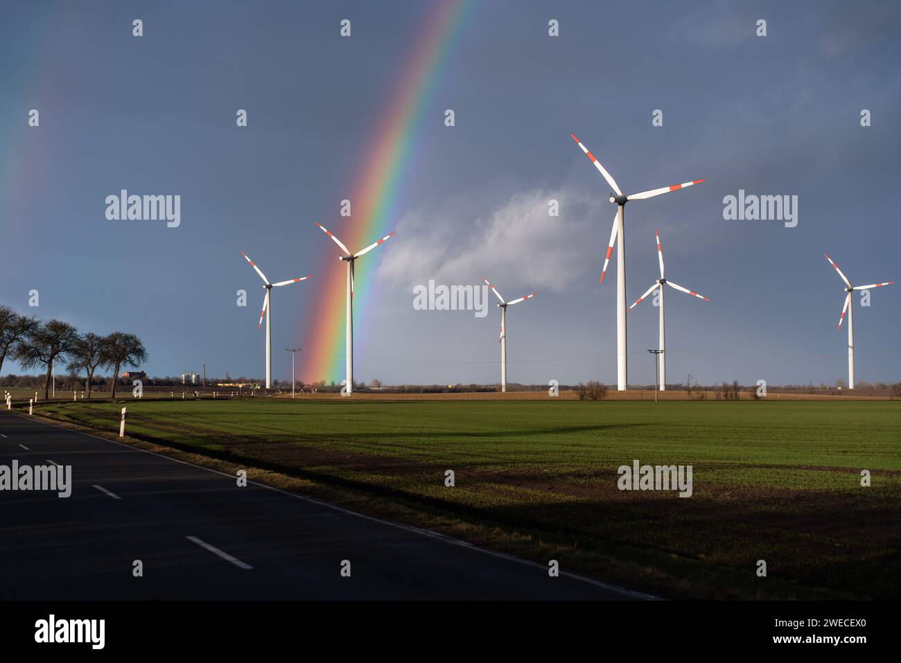 Wind turbines against dark cloudy sky after a thunderstorm. A big ...