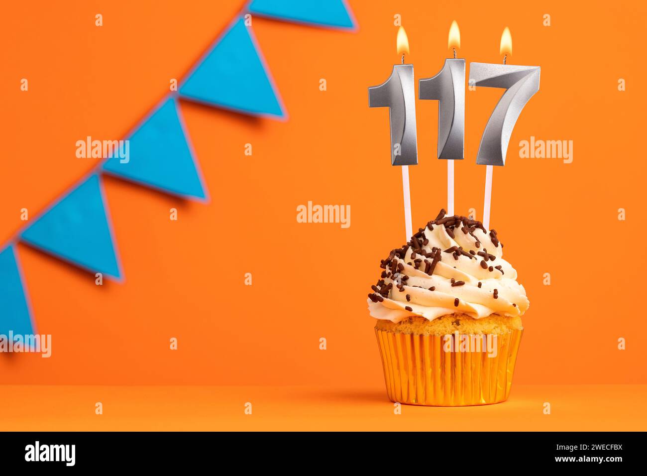 Candle number 117 - Cupcake birthday in orange background Stock Photo ...