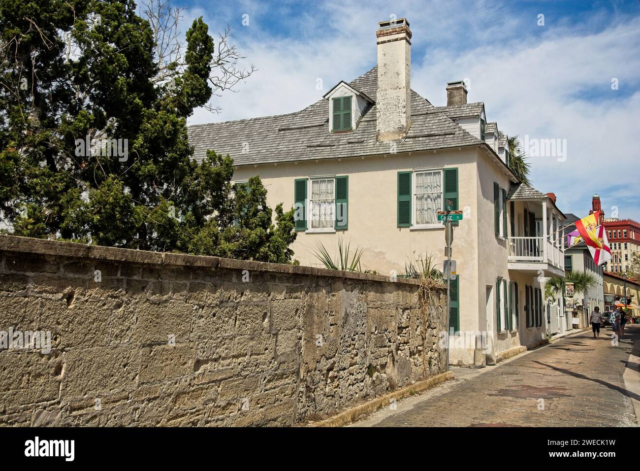 Coquina stone wall along cobblestone road in residential district of St ...