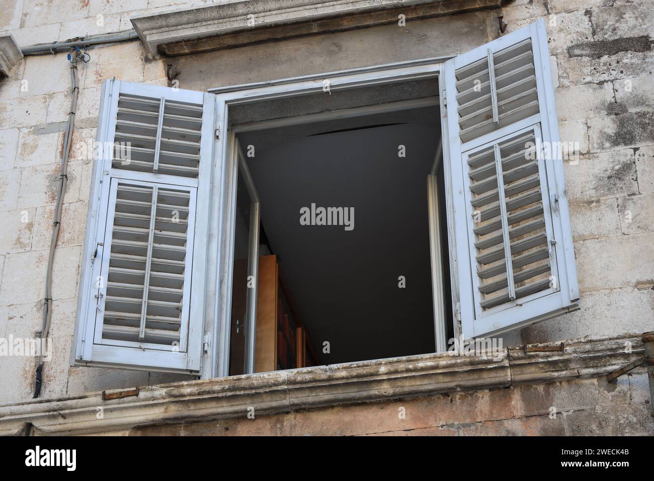 Old residential building with open window and wooden shutters Stock ...
