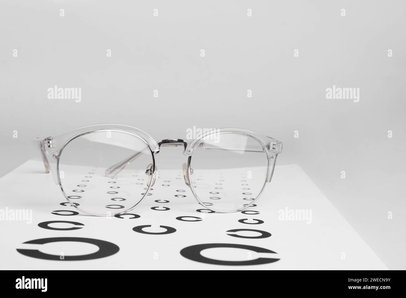 Glasses and vision test chart isolated on white Stock Photo - Alamy
