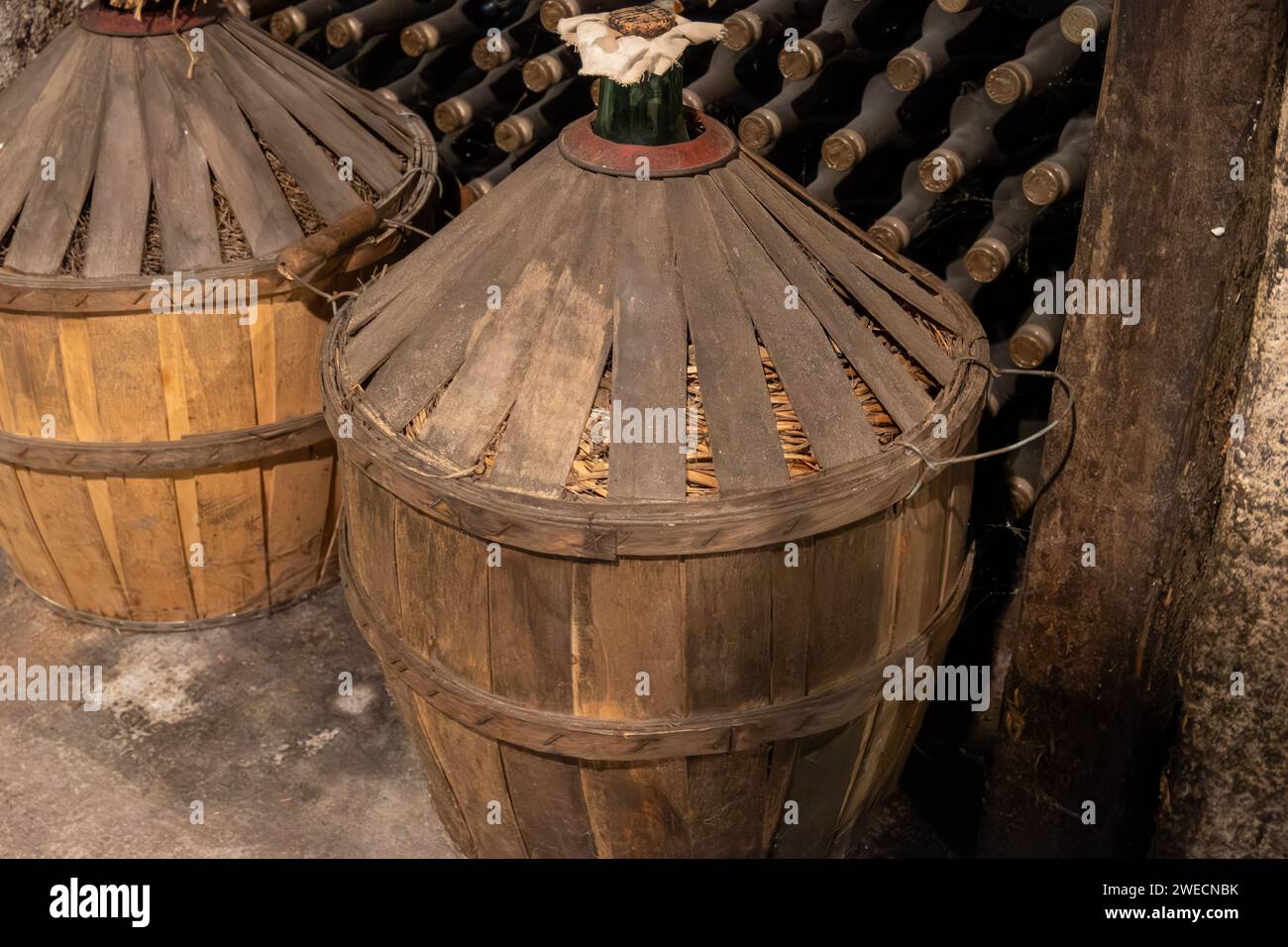 Aging process of cognac spirit in old dark French oak barrels in cellar ...