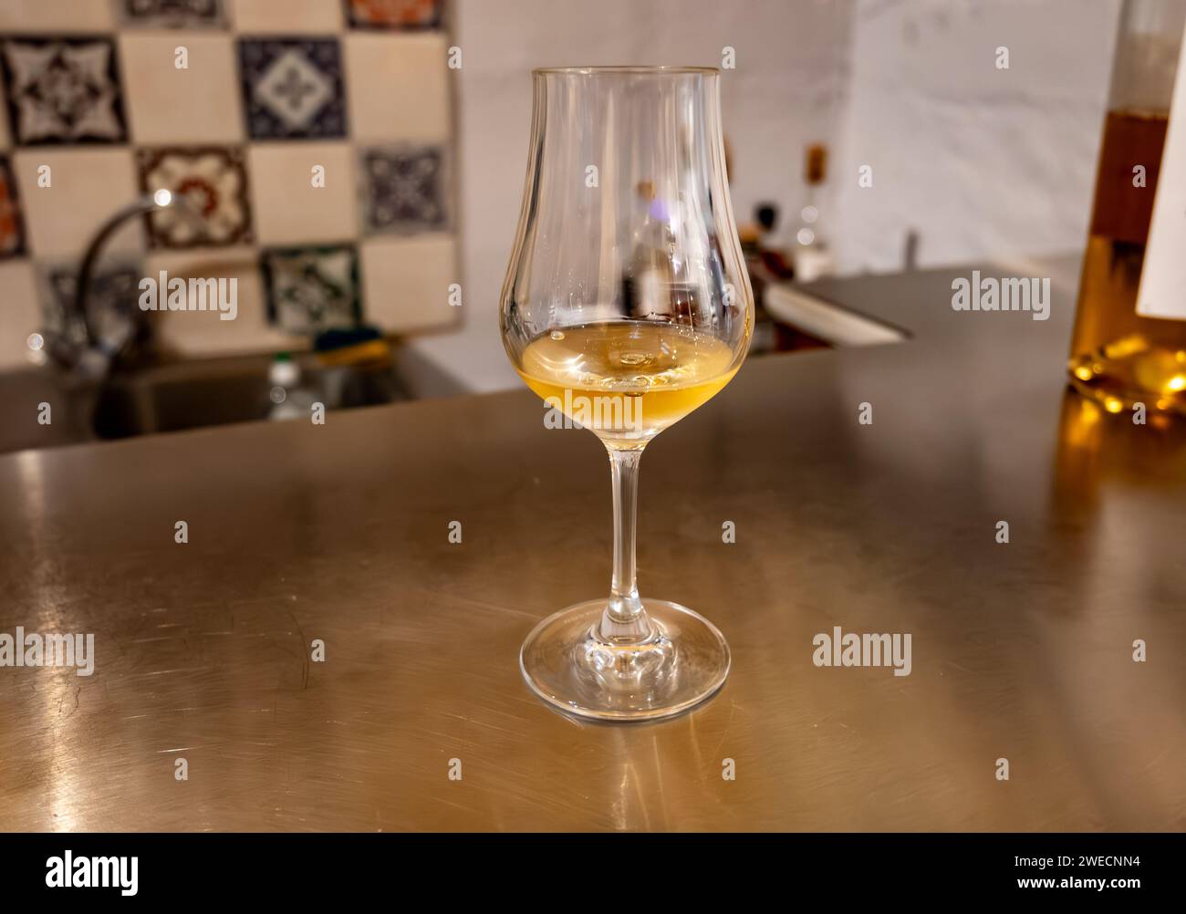 Tasting of cognac spirit aged in old dark French oak barrels in cellar ...