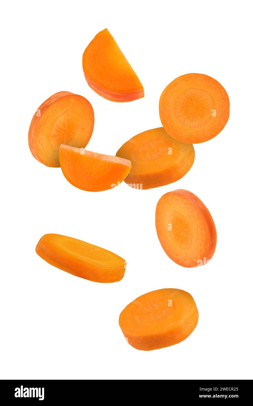 Fresh carrot slices falling on white background Stock Photo - Alamy