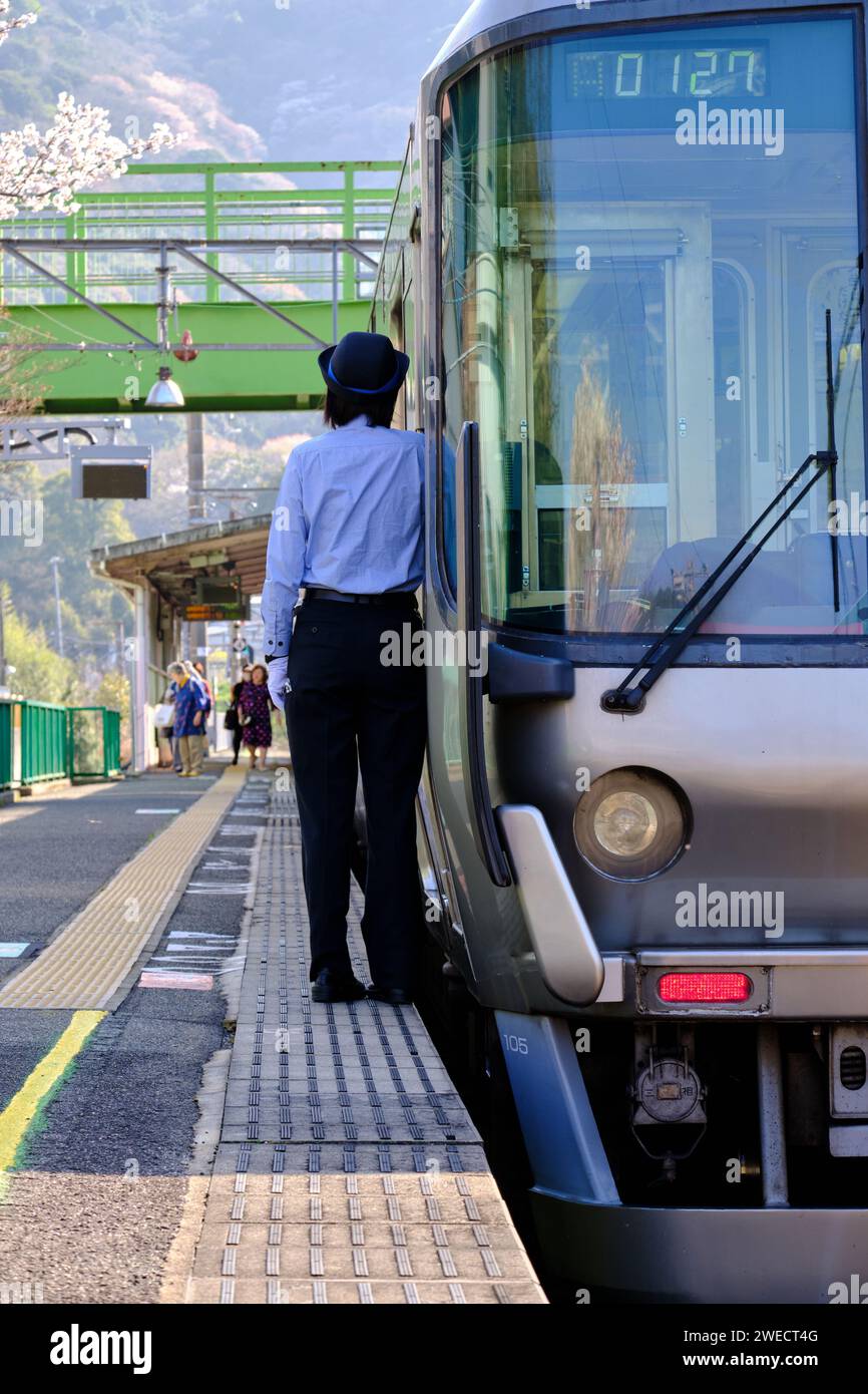 train conductor at end of platform ensuring proper boarding, Japan ...
