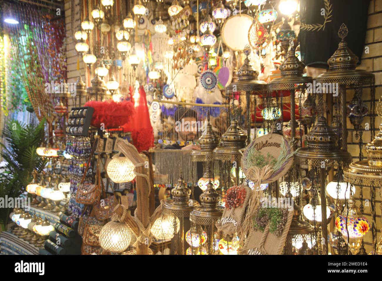Erbil, Iraq. 24th Jan, 2024. A vendor arranges goods at a market in ...