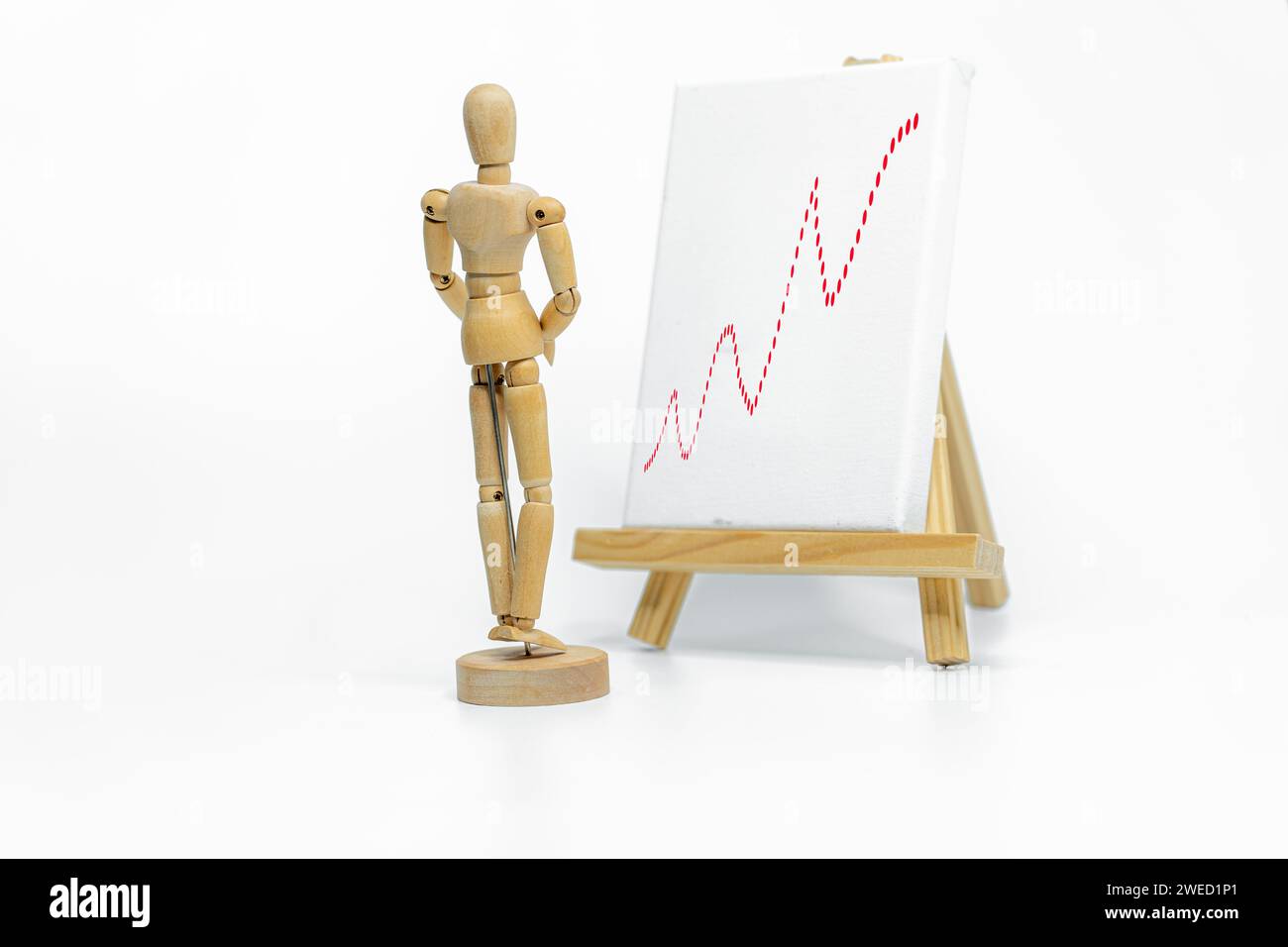 Mannequin drawing a graph charts on easel; isolated on white background ...