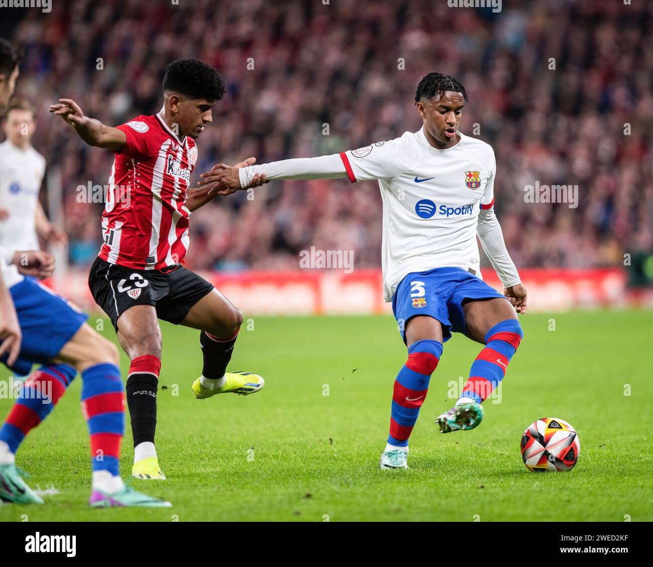 Bilbao, Spain. 24th Jan, 2024. Malcom Adu Ares (L) of Athletic Club and Alejandro Balde (R) of F ...
