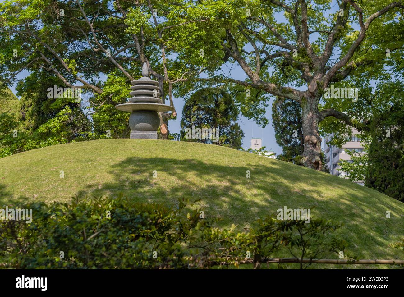 Round stone carved pagoda on hilltop in Hiroshima Peace Park in ...